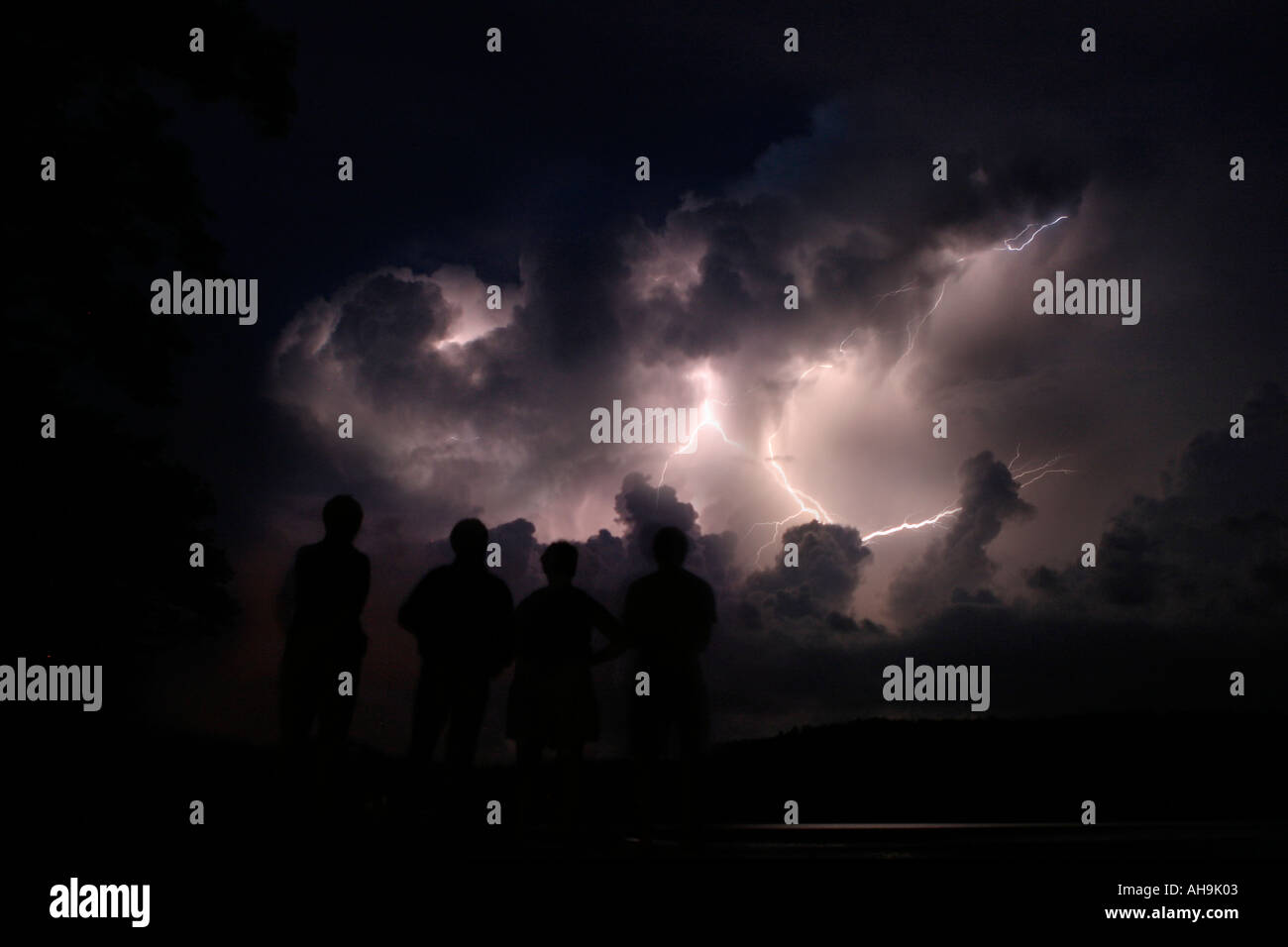 Summer Storm Clouds Lightning people in silhouette Stock Photo - Alamy