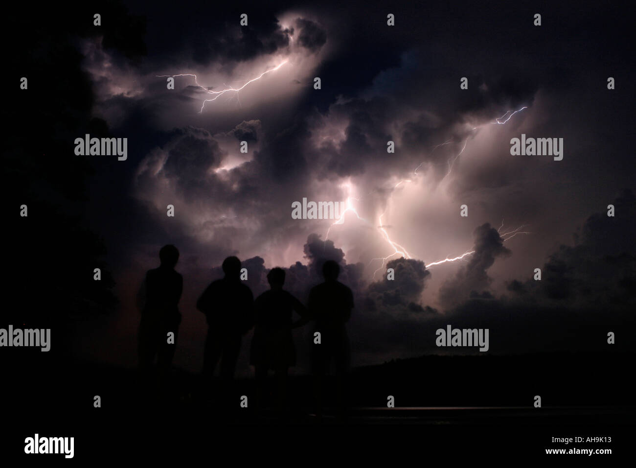 Summer Storm Clouds Lightning people in silhouette Stock Photo - Alamy