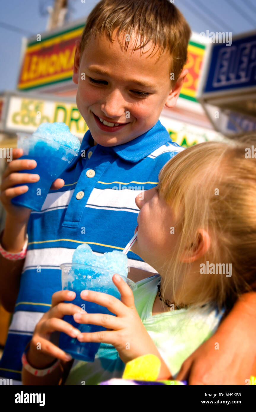 Kids eating carnival food Stock Photo - Alamy