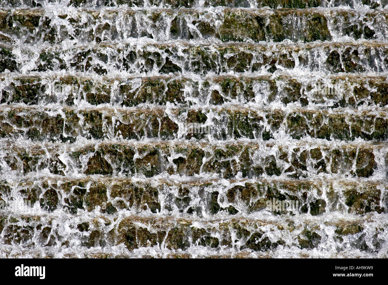 Cascading water flowing over waterfall steps Stock Photo - Alamy
