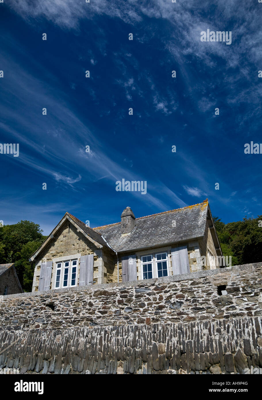 A building and sea wall at Durgan Village on the Helford River ...