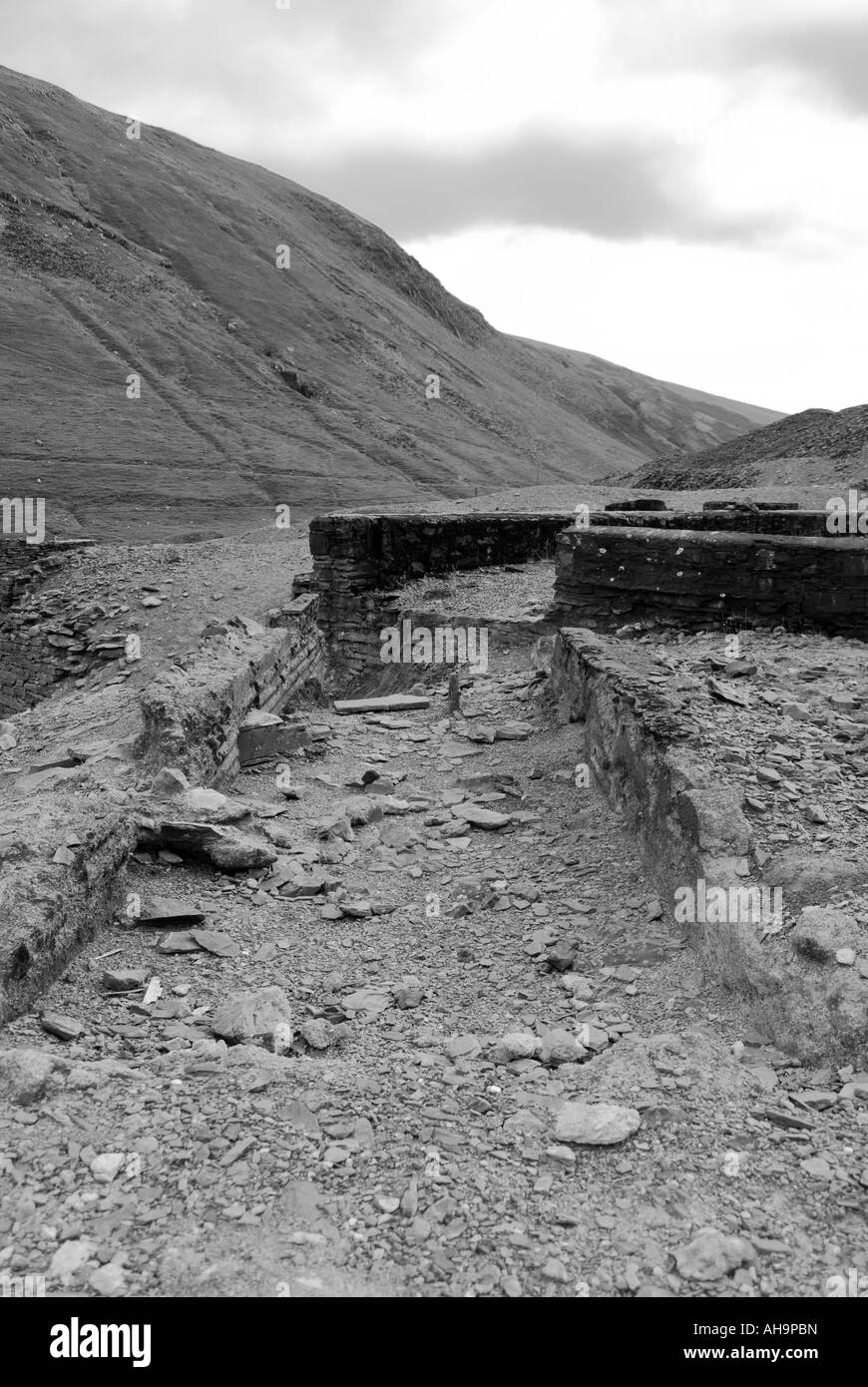 Black and white image of a trough in the ground in a deserted lead ...