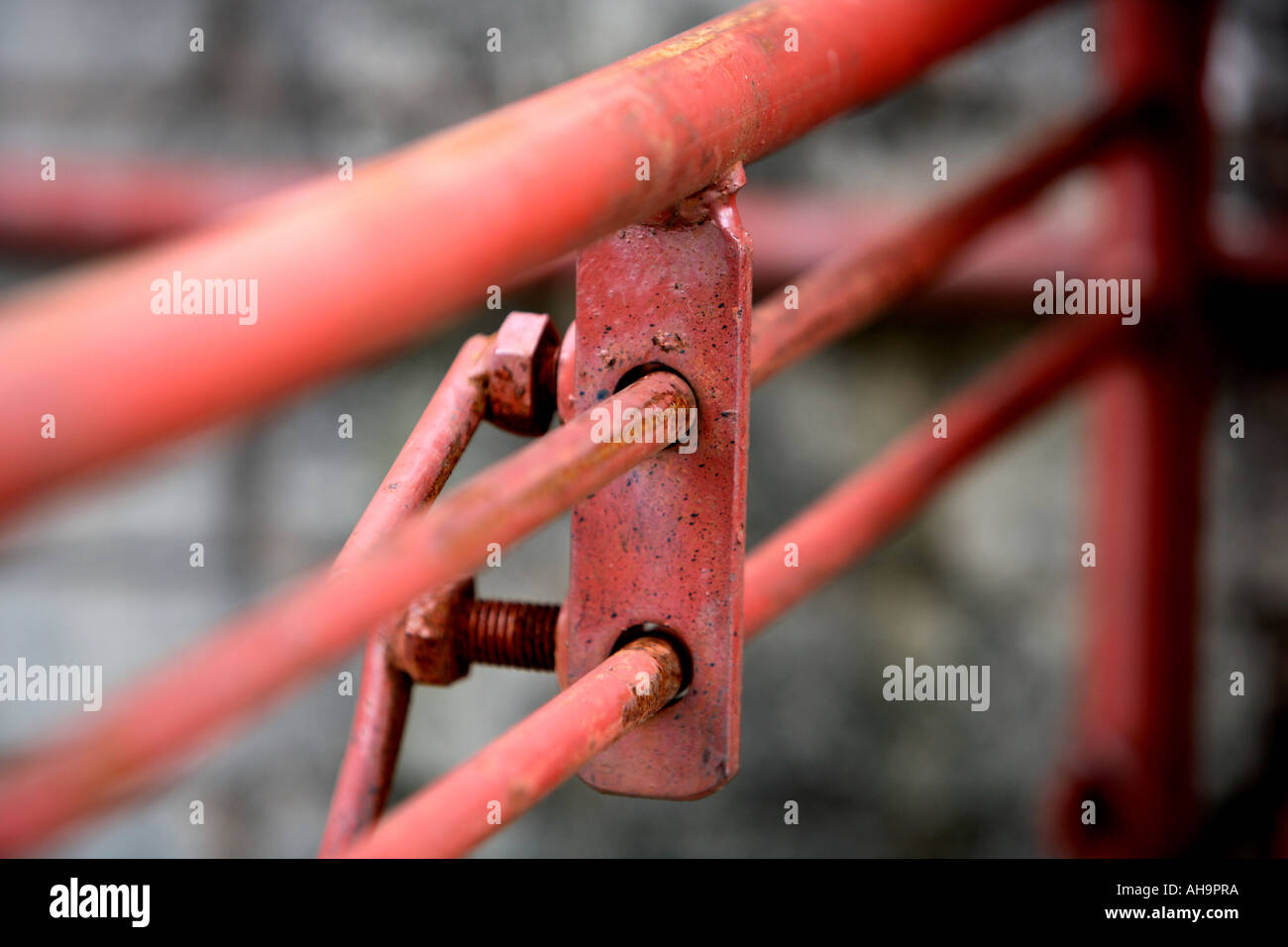 Horizontal close up landscape detail of red metal bars in scene of ...