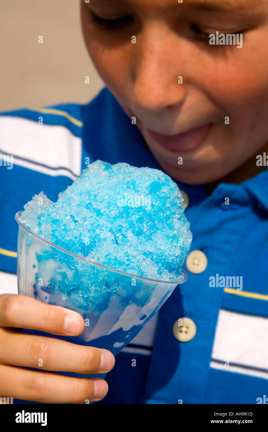 Boy eating carnival food Stock Photo - Alamy