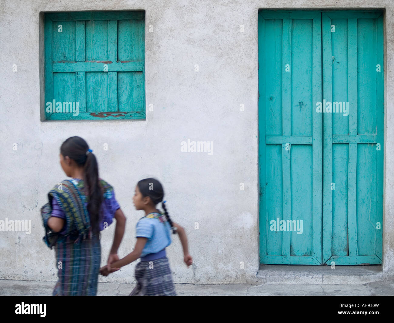 Woman and child pass doorway Stock Photo - Alamy