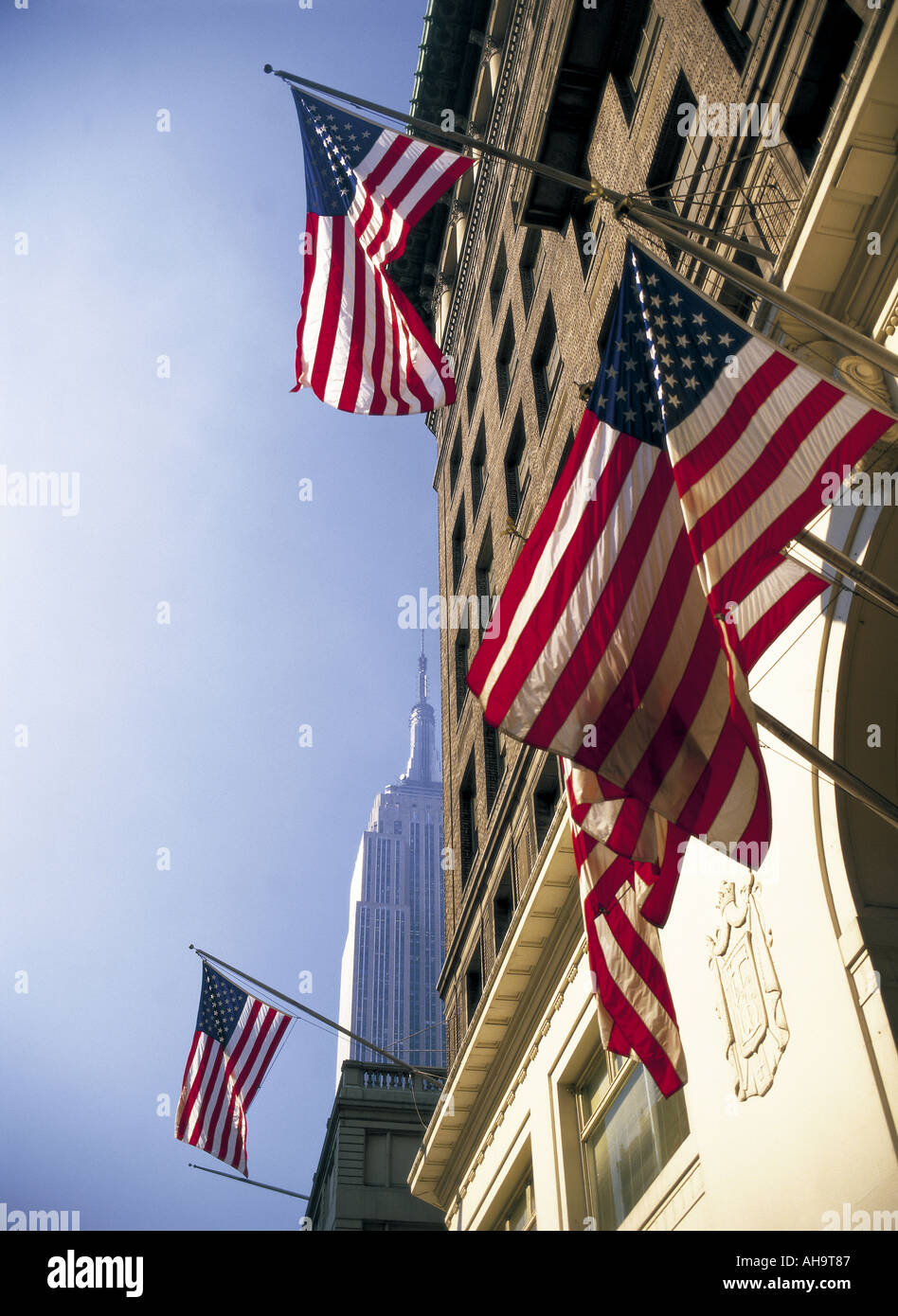 US flags and Empire State Building, New York, USA Stock Photo - Alamy