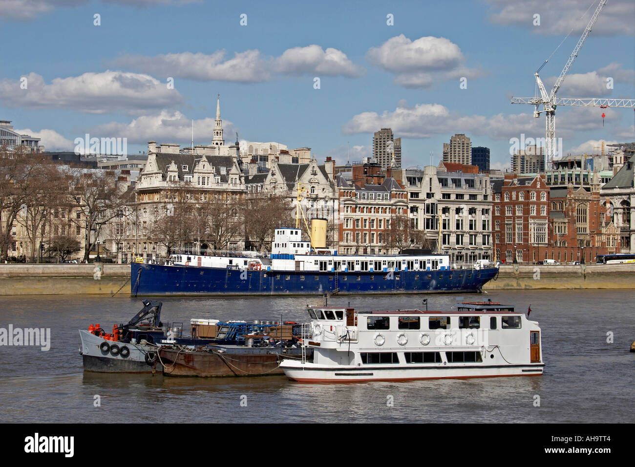 View on sunny day north across River Thames with boats HMS President ...