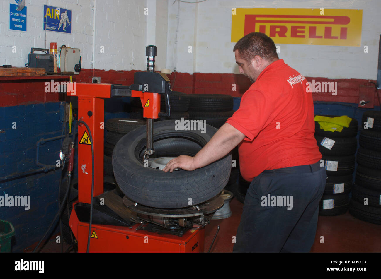 A Man Changing A Tyre Stock Photo - Alamy