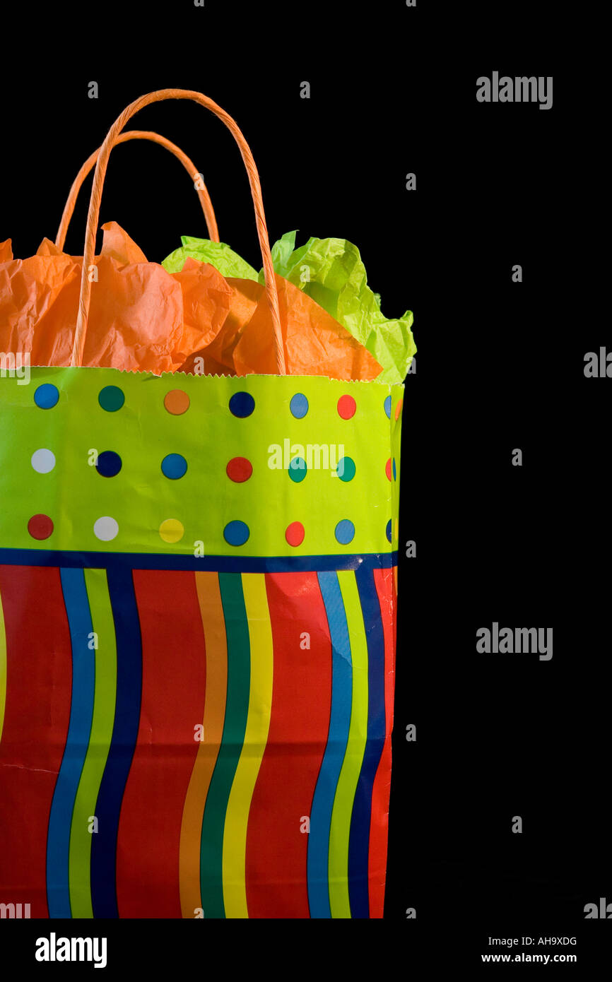 Present in Bright Colored Gift Bag Stock Photo - Alamy