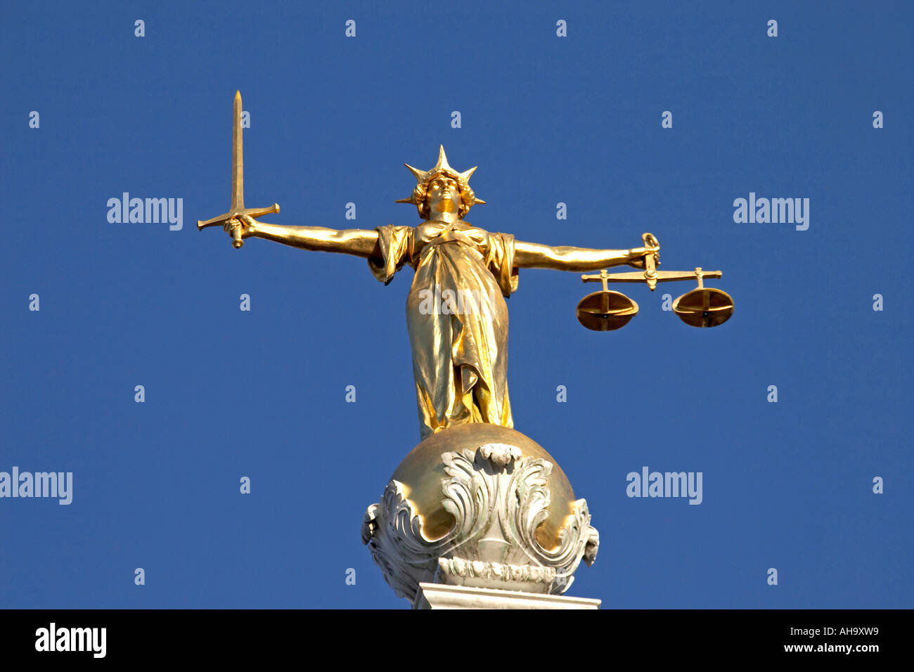 Gold statue of Justice with balance scales and sword on the roof dome ...