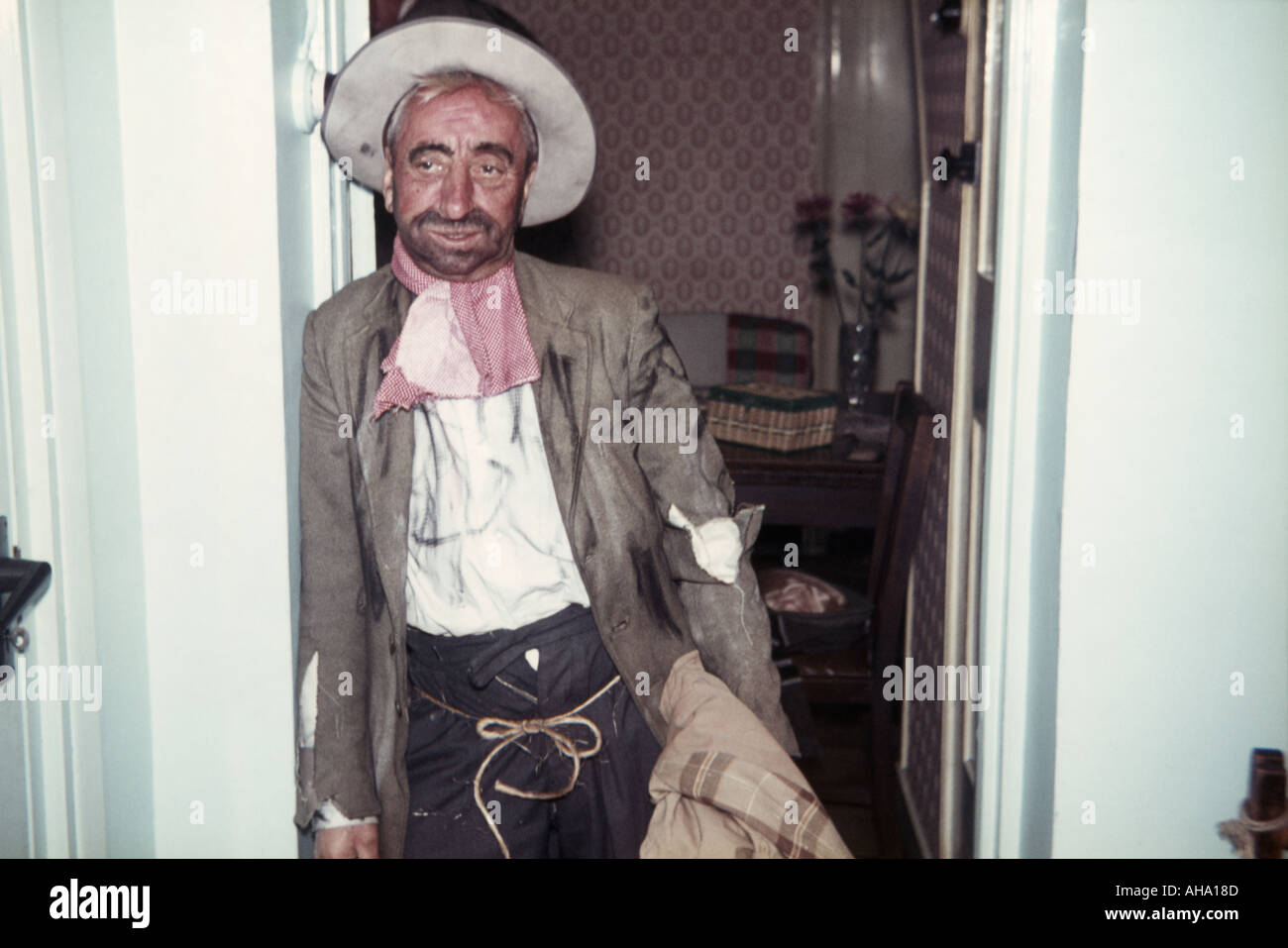 portrait off a old lonely male tramp standing upright in a door way ...