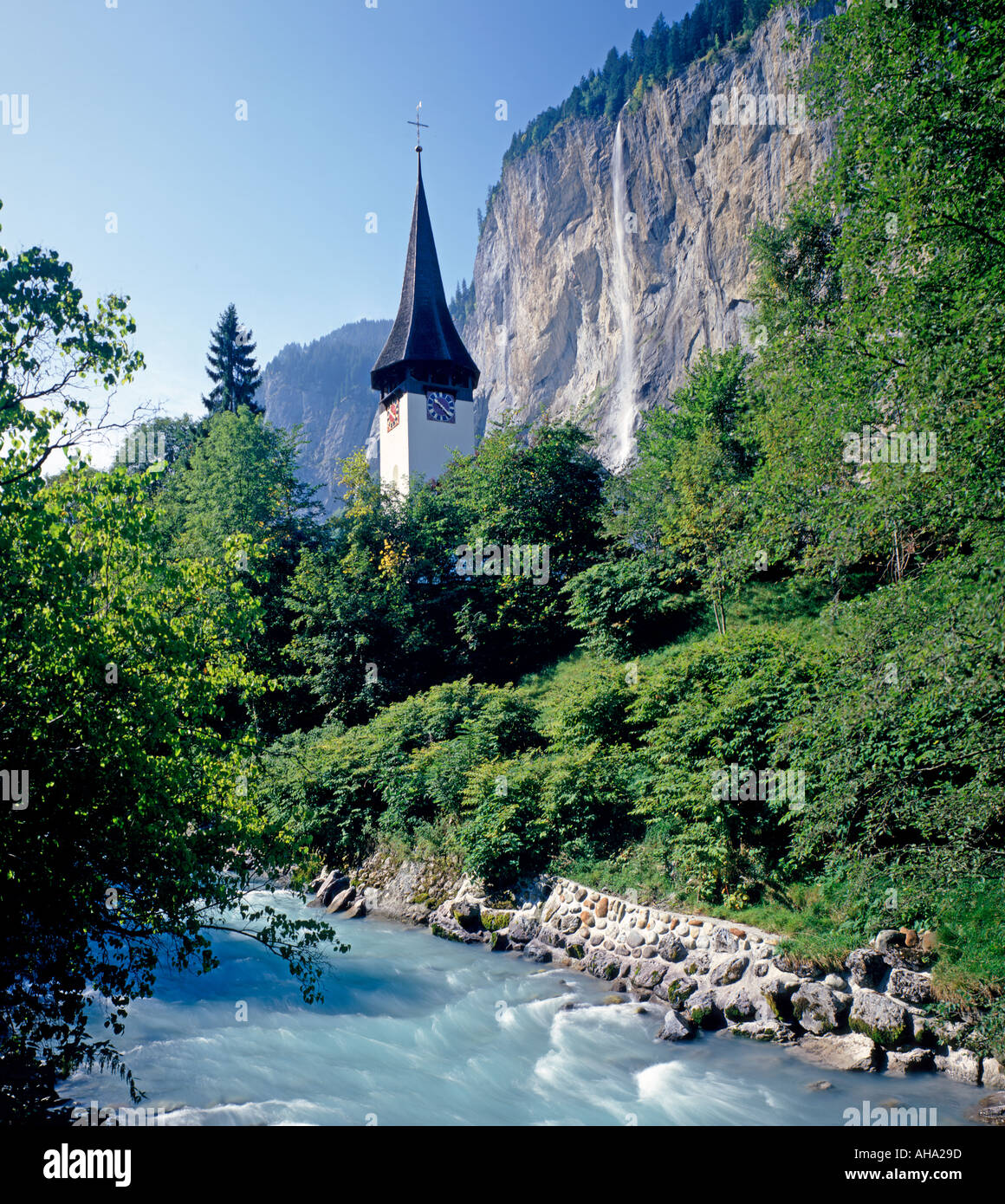 waterfall and church in Alpine village of Lauterbrunnen Switzerland ...
