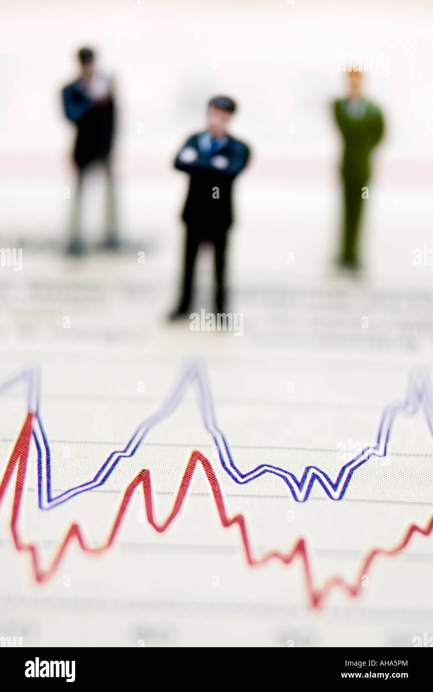 Businessmen standing on graph Stock Photo - Alamy