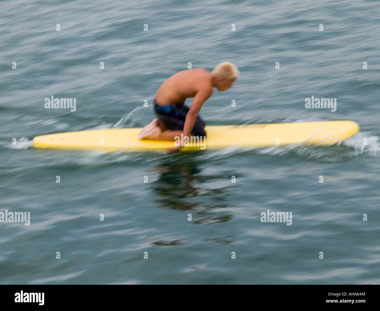Surfer yellow suit board hi-res stock photography and images - Alamy