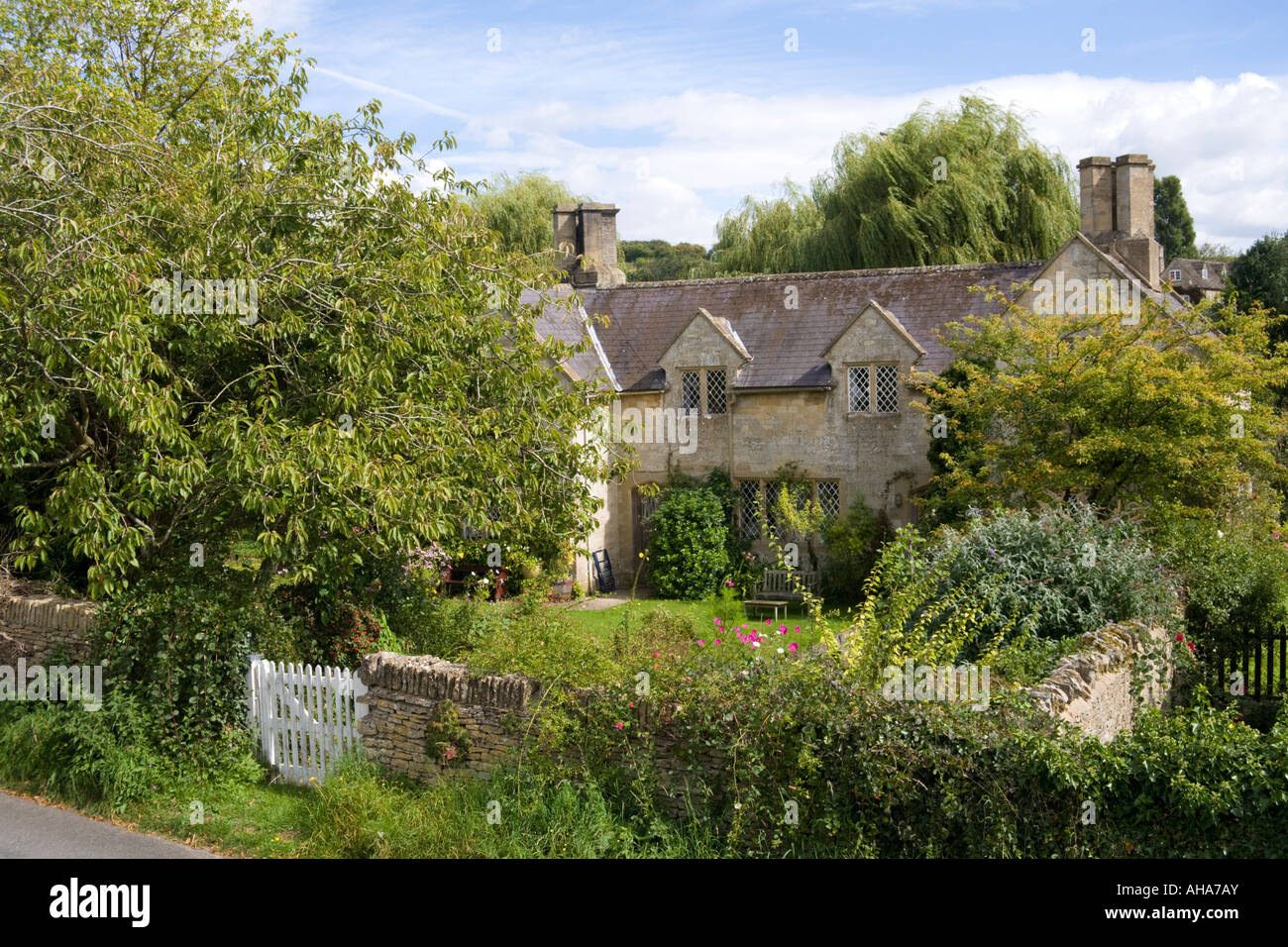 A rustic stone cottage in the Cotswold village of Swinbrook ...