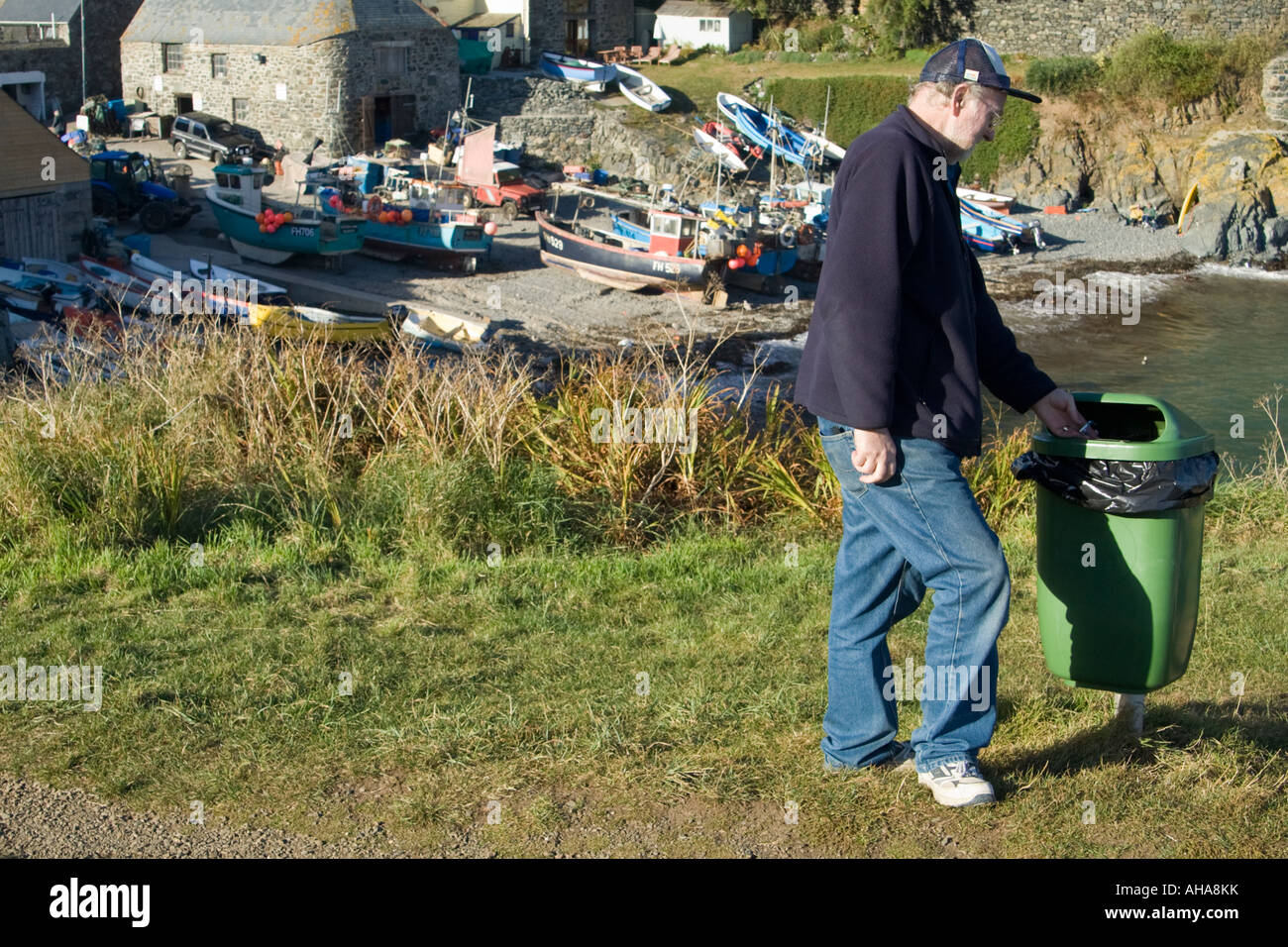 Man putting litter into a bin Stock Photo - Alamy