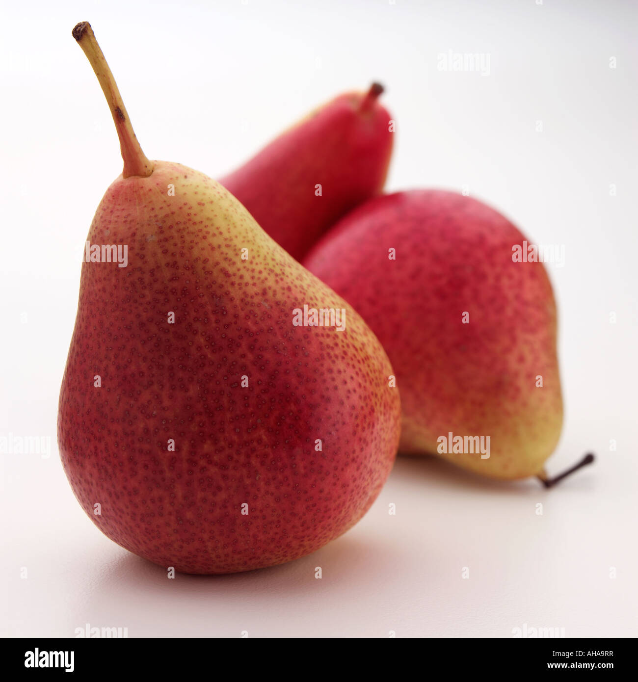 Three red pears on a white background editorial food Stock Photo - Alamy