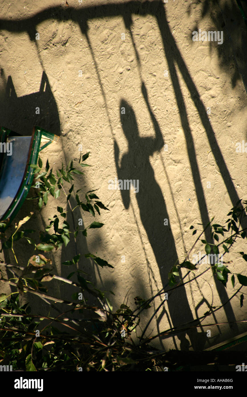 Shadow of child on swing Stock Photo - Alamy
