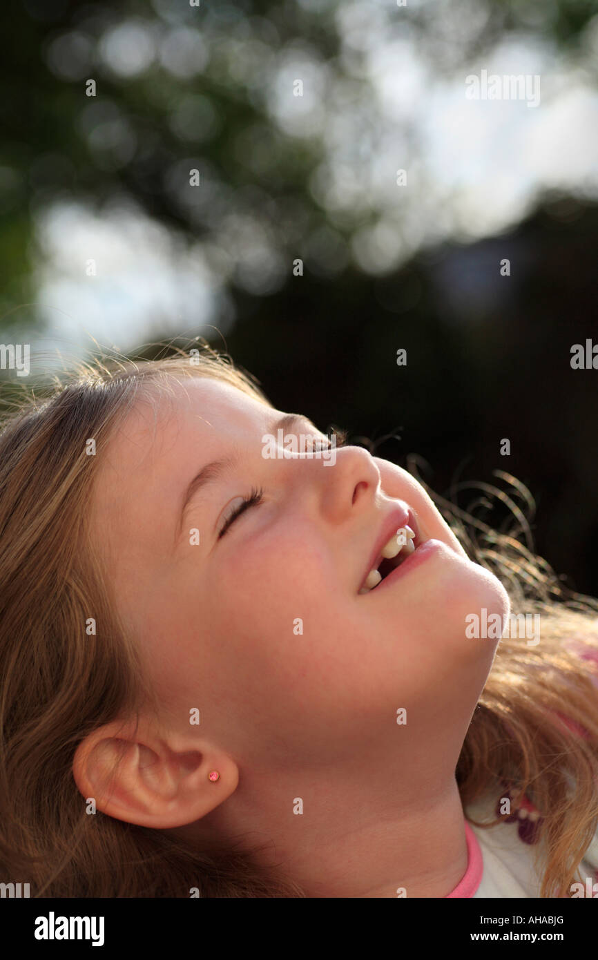 A young girl laughing in Summer sunshine Stock Photo - Alamy