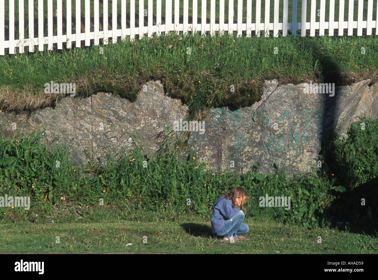 Sad girl in grass Stock Photo - Alamy