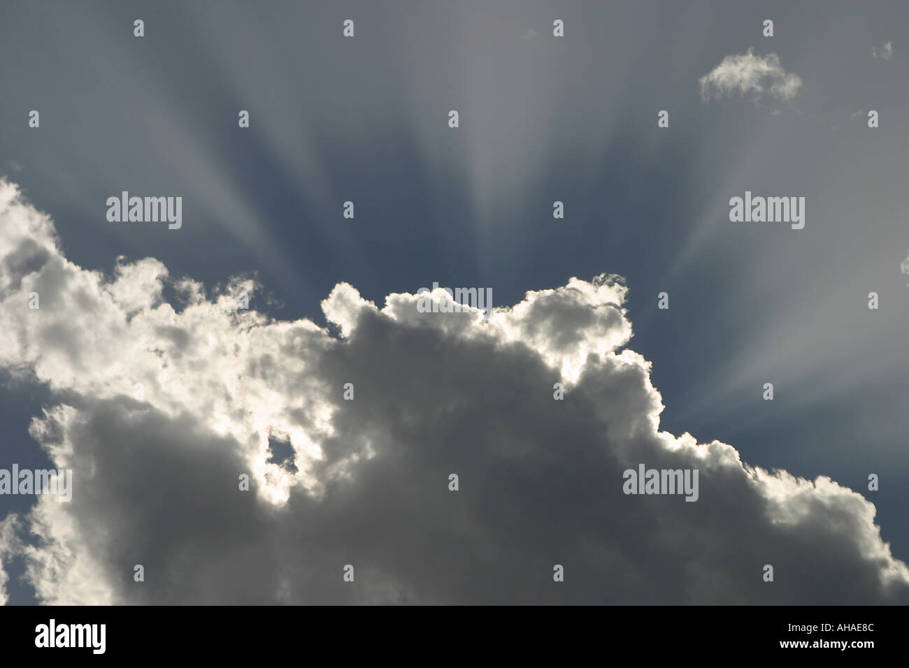 sun streaks behind cloud Stock Photo - Alamy