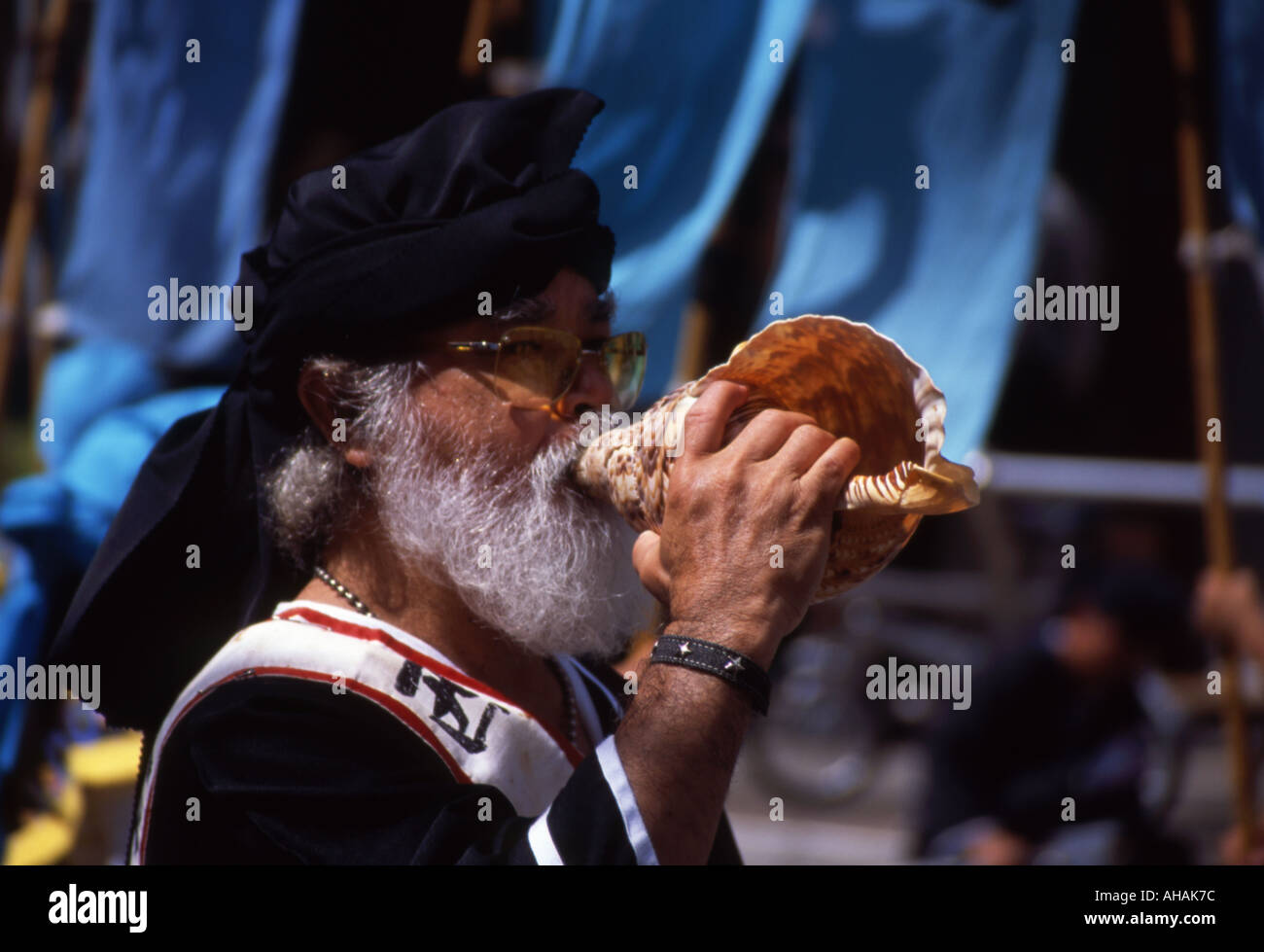 Man playing the conch shell at Naha Tug of War Okinawa Japan Stock ...