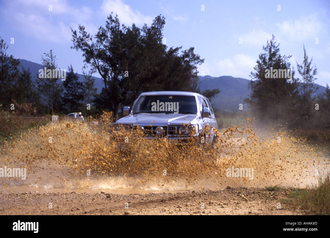 Toyota Hilux 4x4 churns through a muddy pool Stock Photo - Alamy