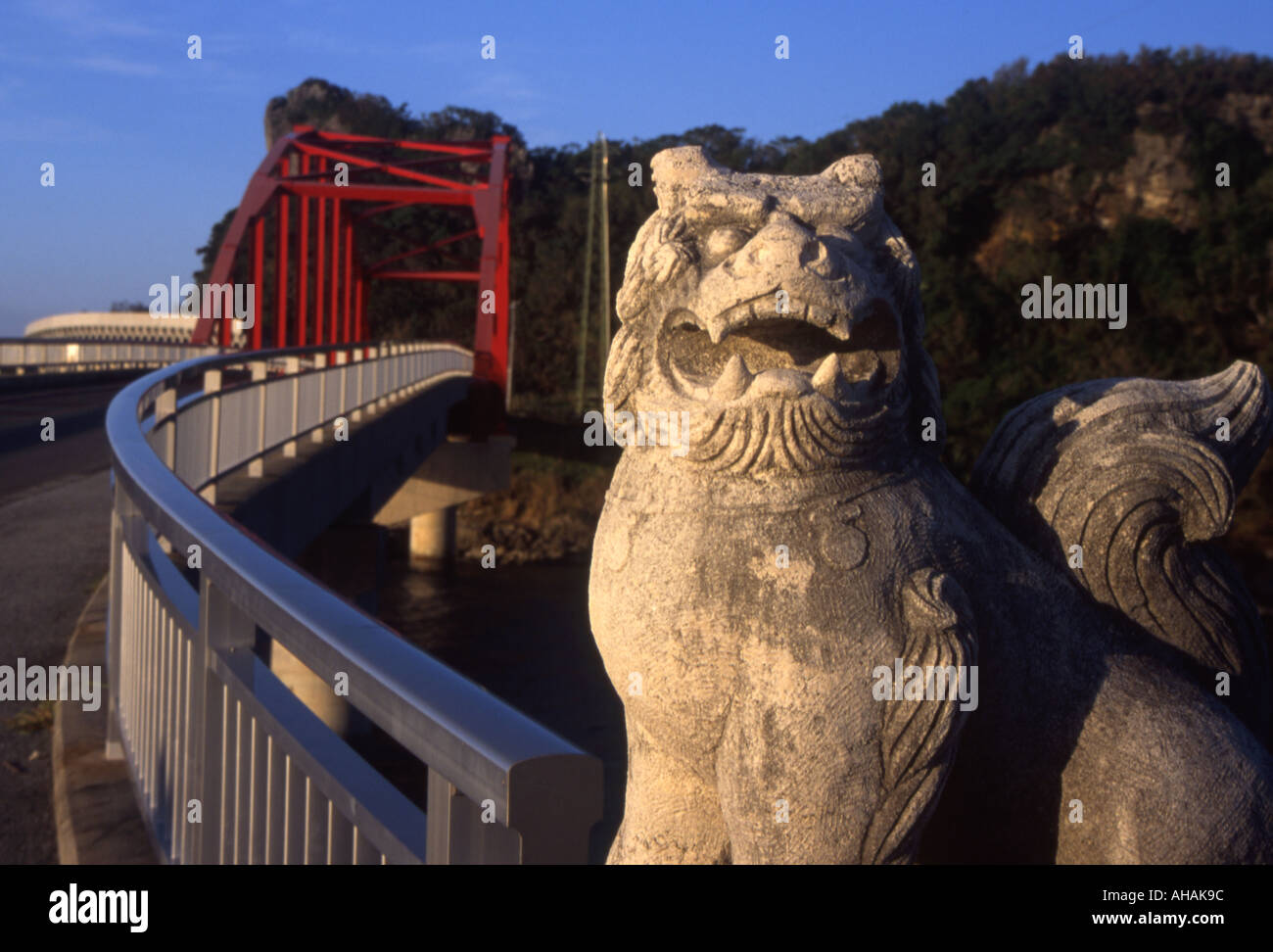 Shisa lion dog statue stands before the bridge to Ikei Island Okinawa ...