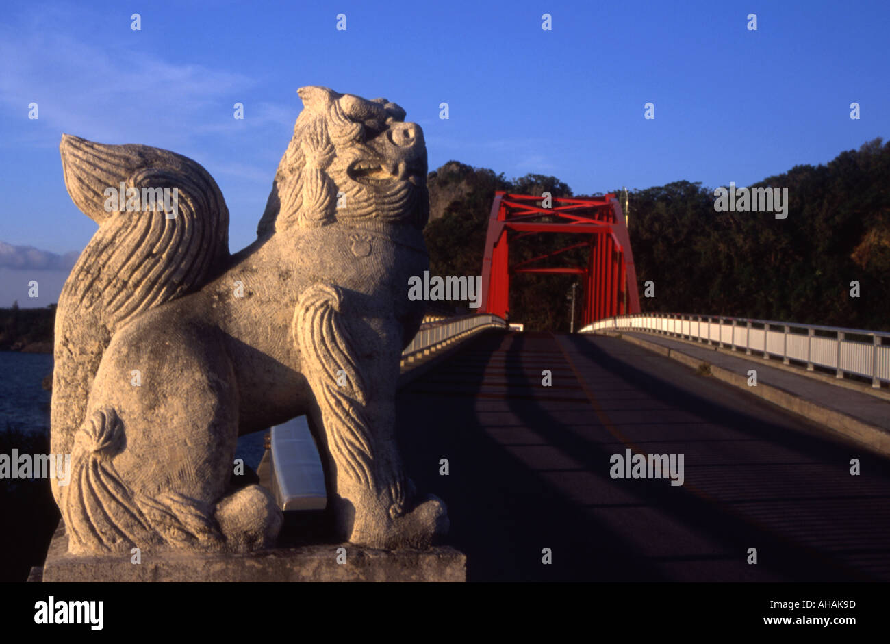 Shisa lion dog statue stands before the bridge to Ikei Island Okinawa ...