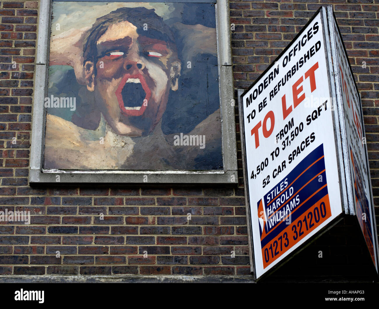 To Let sign on empty office building with mural portrait painted on ...