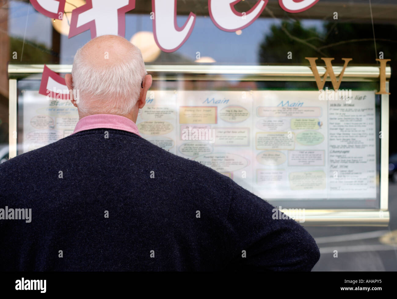 Elderly man inspecting resteraunt window menu Stock Photo - Alamy