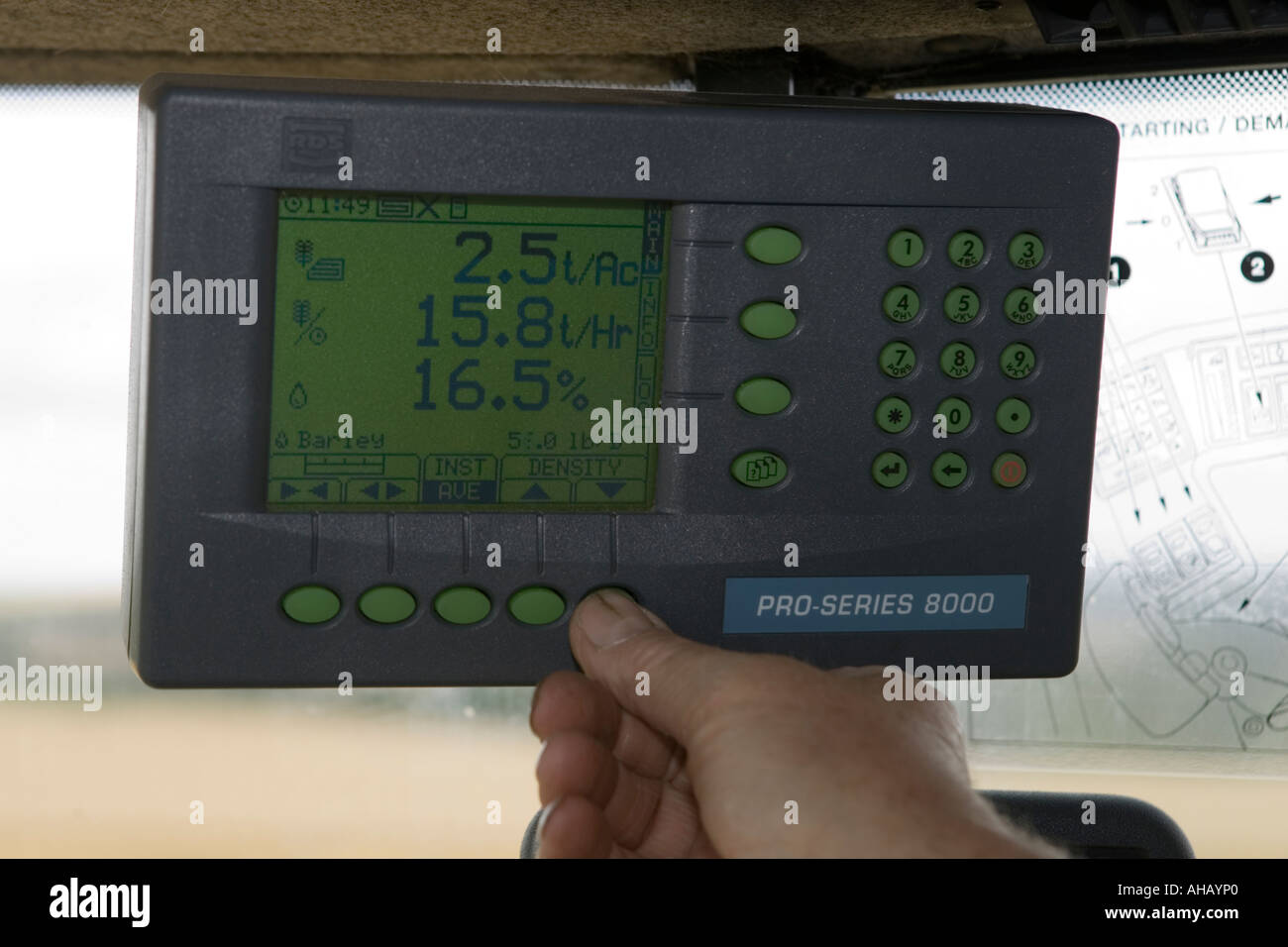 Adjusting yield monitor in cab combine harvester Wiltshire England UK ...