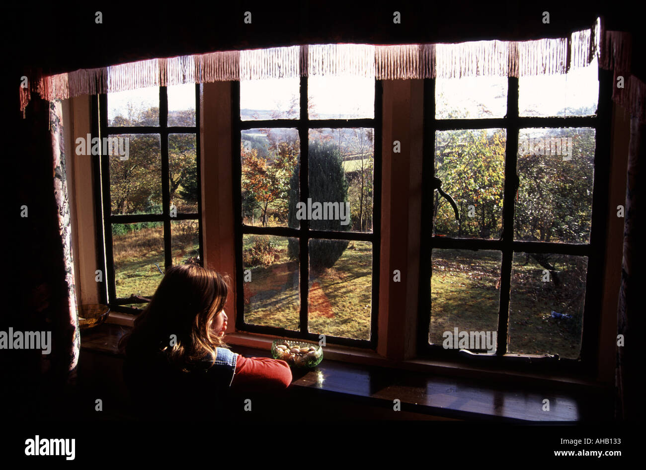 Child watching out of window Stock Photo - Alamy