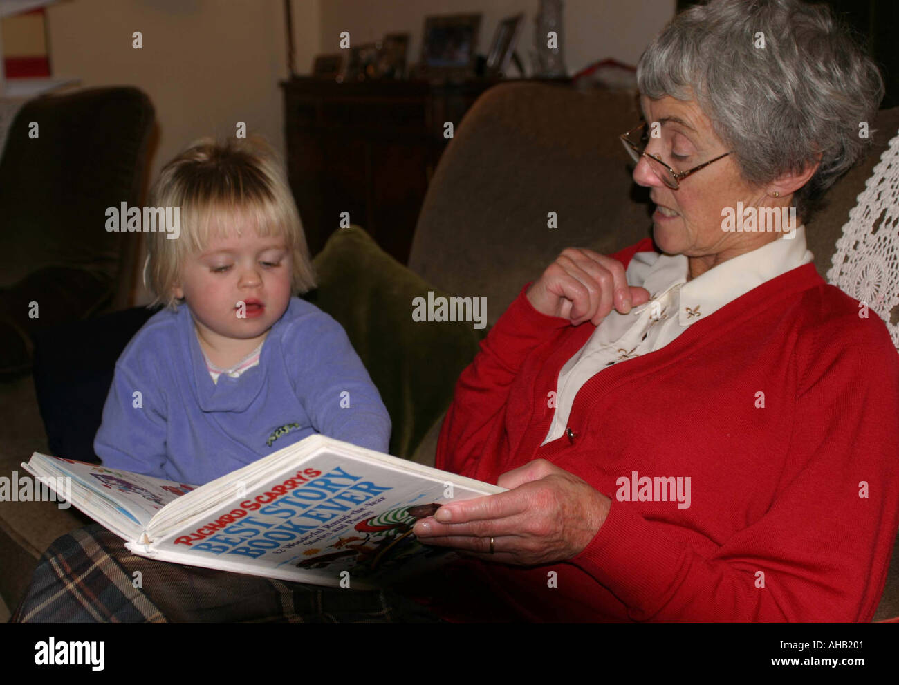 Grandmother reading to child Stock Photo - Alamy