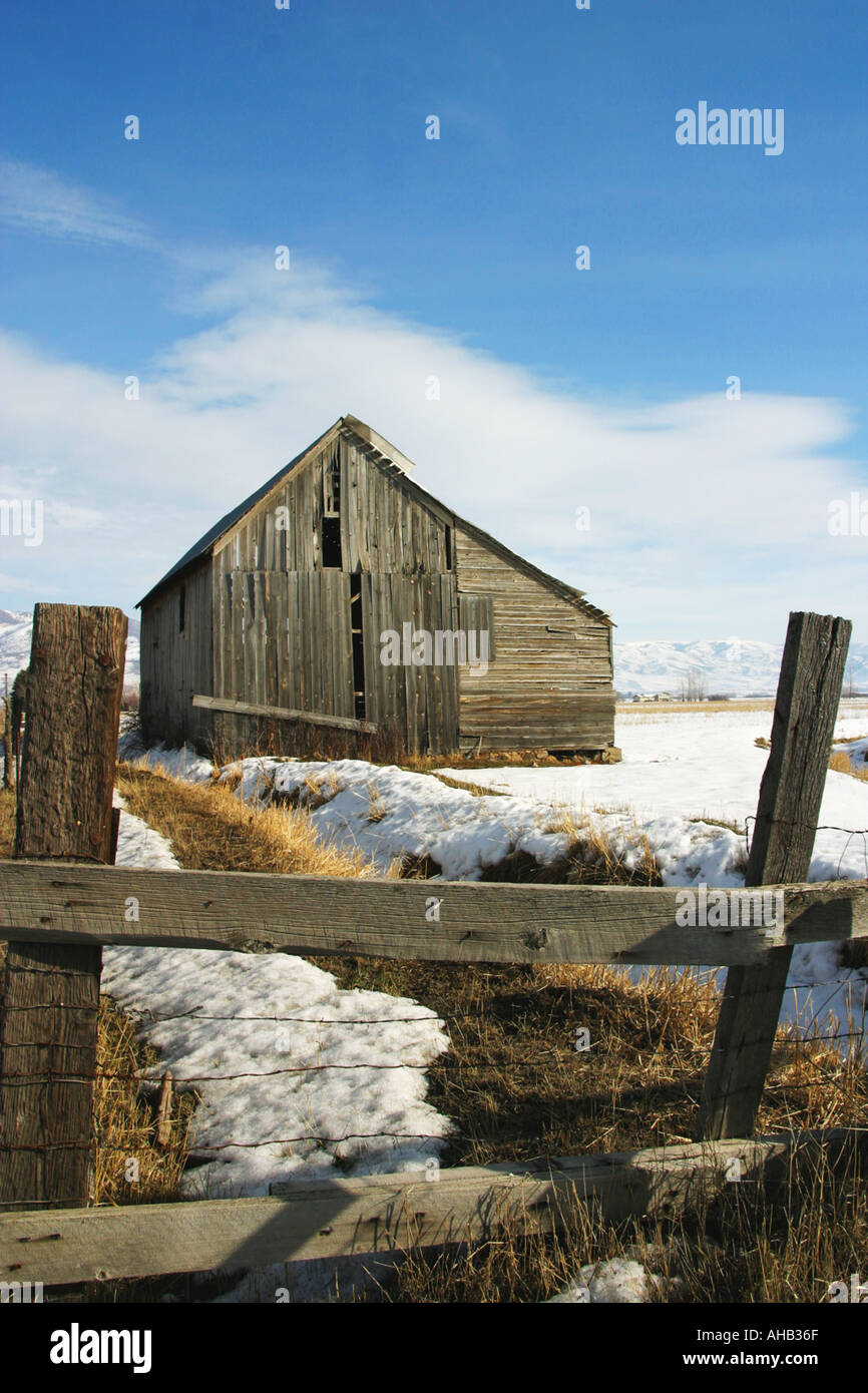 Needing paint but still standing strong is this old fence and barn near ...