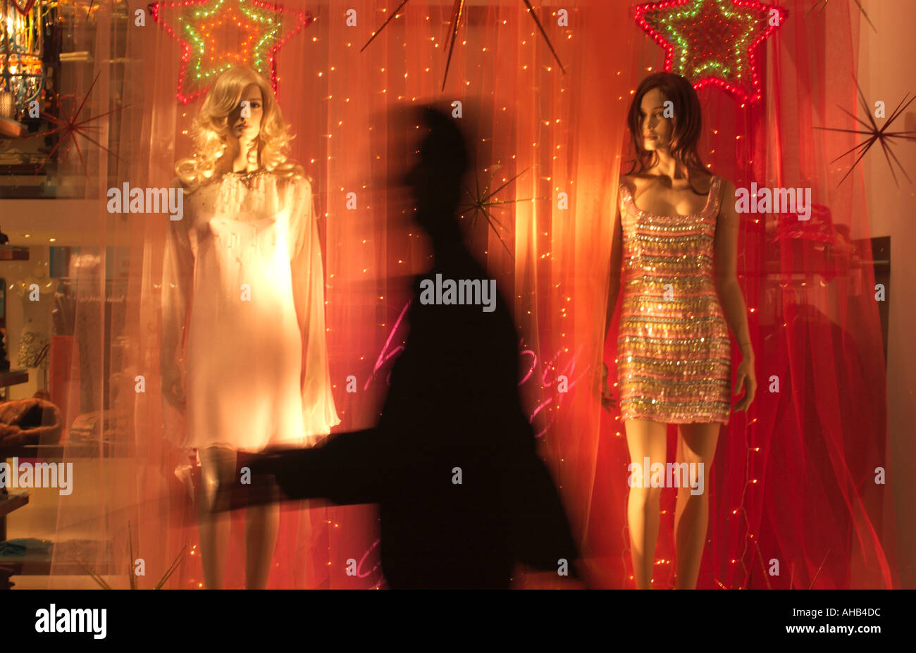 iluminated store window with showroom dummies and a consumers ...