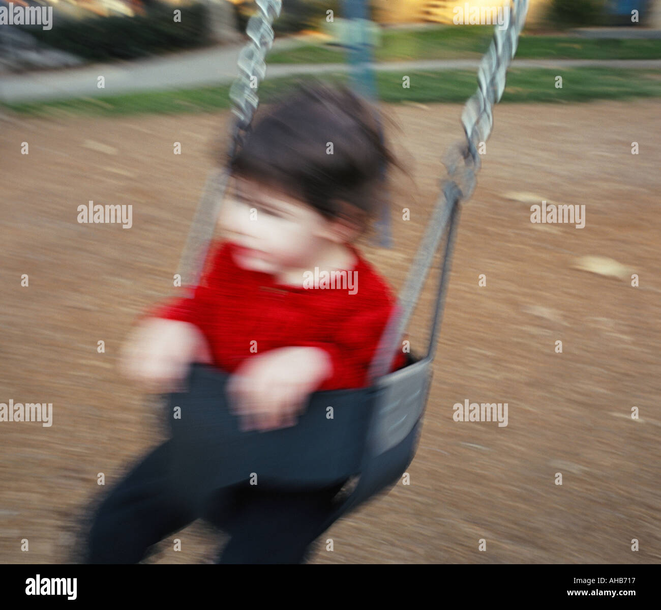 Child swinging on a swing happy Stock Photo - Alamy