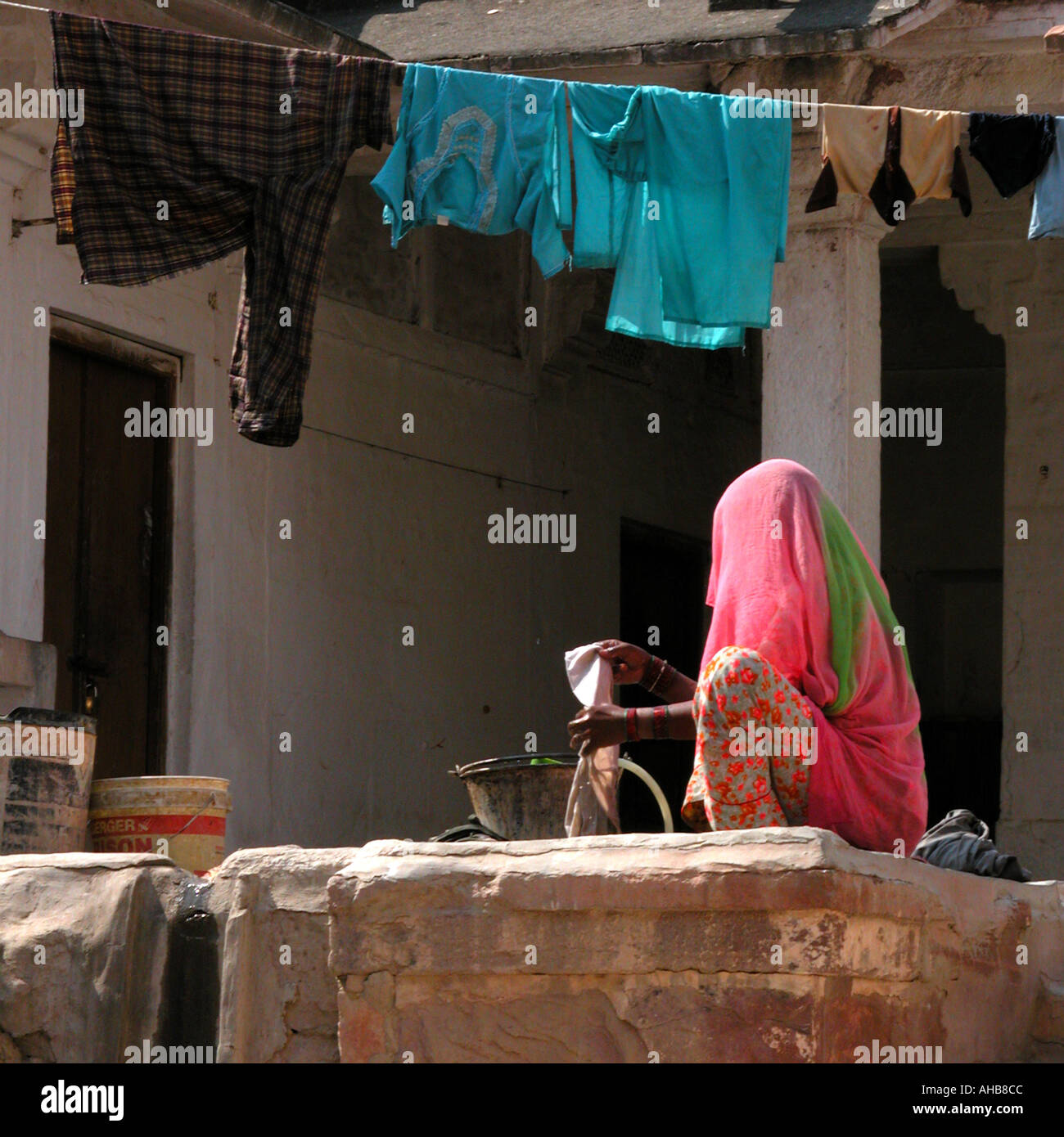 Indian woman washing clothes by hand hi-res stock photography and ...