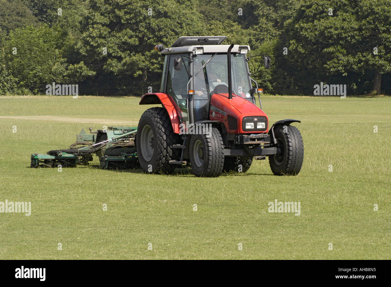 tractor cutting the grass on the cricket pitch Stock Photo - Alamy
