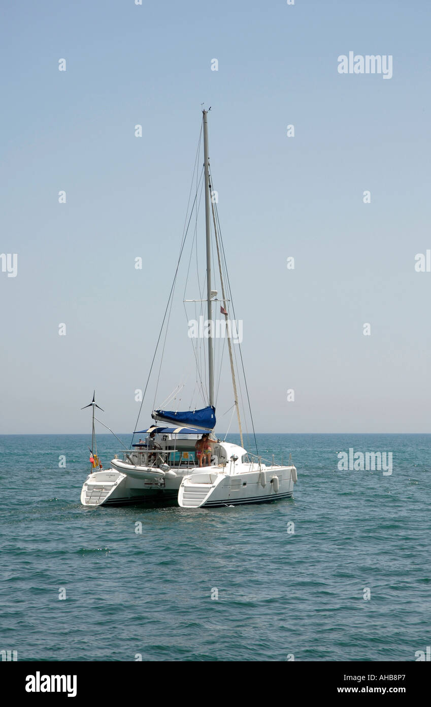 catamaran under power with sails down Stock Photo - Alamy
