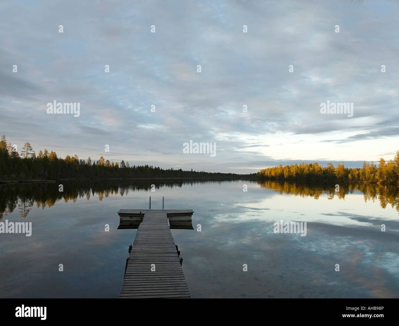 still lake like mirror with footbridge in Finland Stock Photo - Alamy