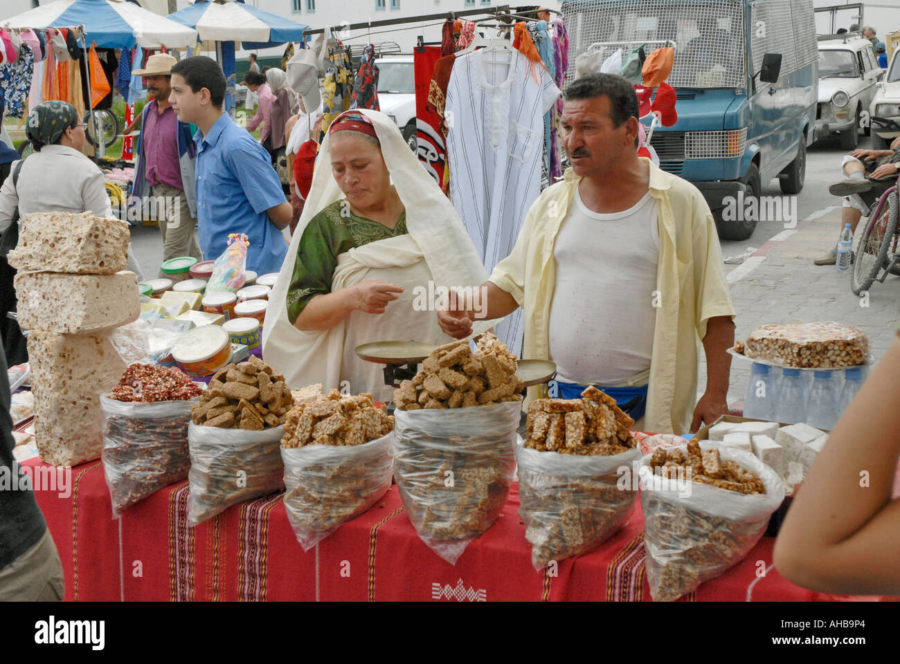 Local man and woman selling cakes and biscuits at Hammamet market in ...