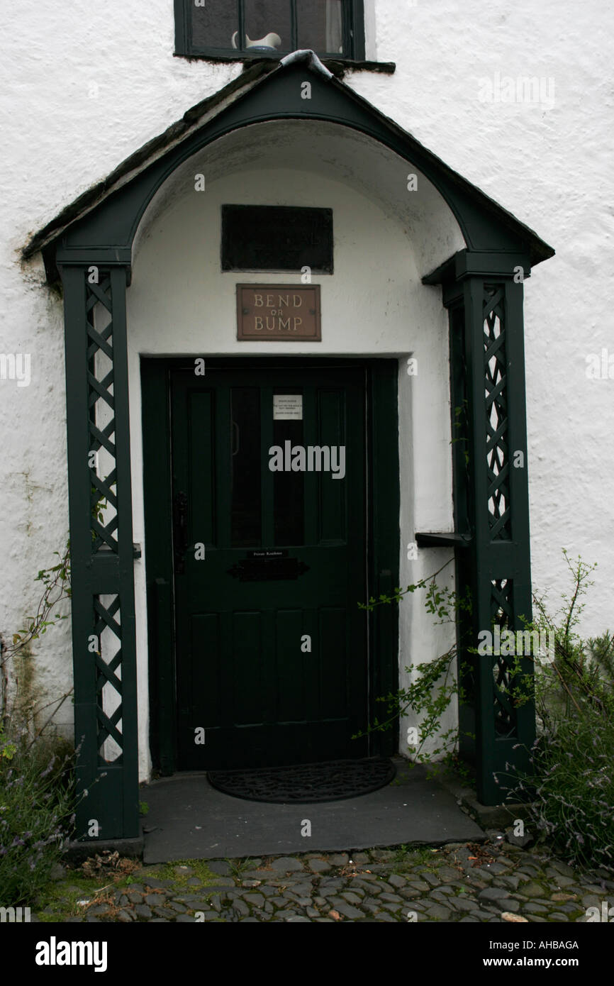 Low door with amusing "Bump or bend " sign Stock Photo - Alamy