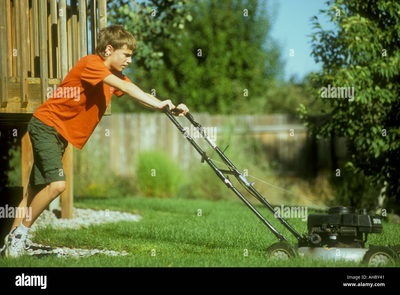 Boy Mowing The Lawn Stock Photos & Boy Mowing The Lawn Stock Images - Alamy