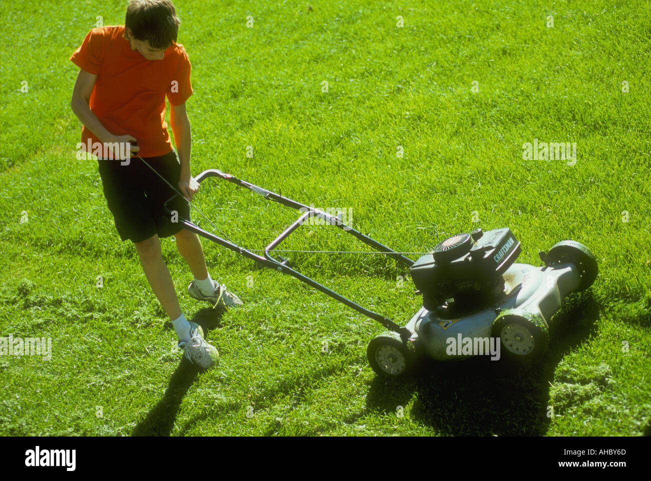 Boy Mowing The Lawn Stock Photos & Boy Mowing The Lawn Stock Images - Alamy
