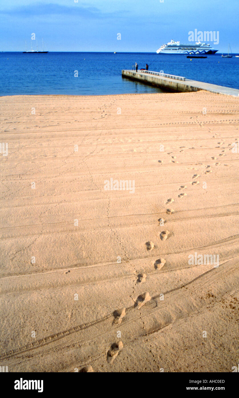 Footprints in the sand at Cannes France cruise ship and four masted ...