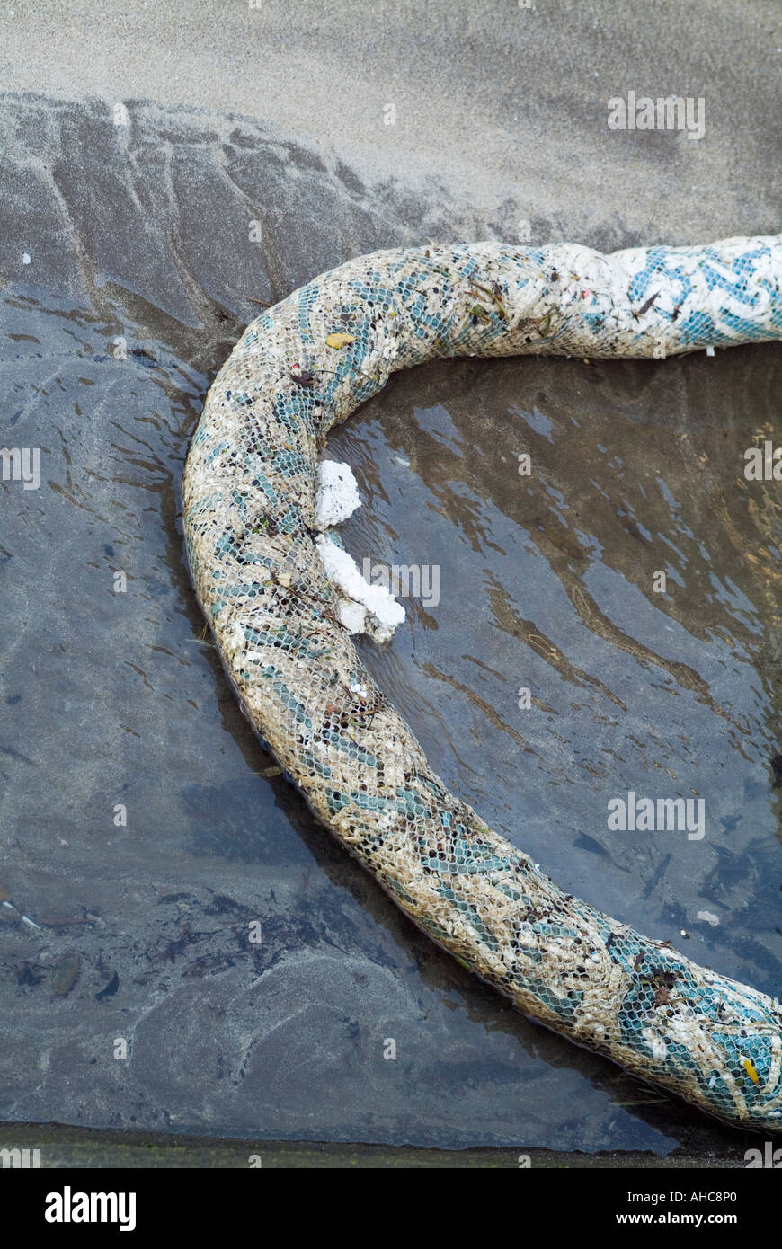 Floating boom in a stream catching floating plastic debri preventing it ...