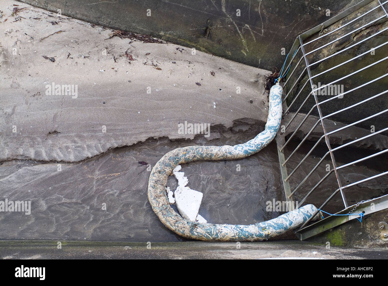 A netting floating boom tied to a grating catches polluting plastic ...