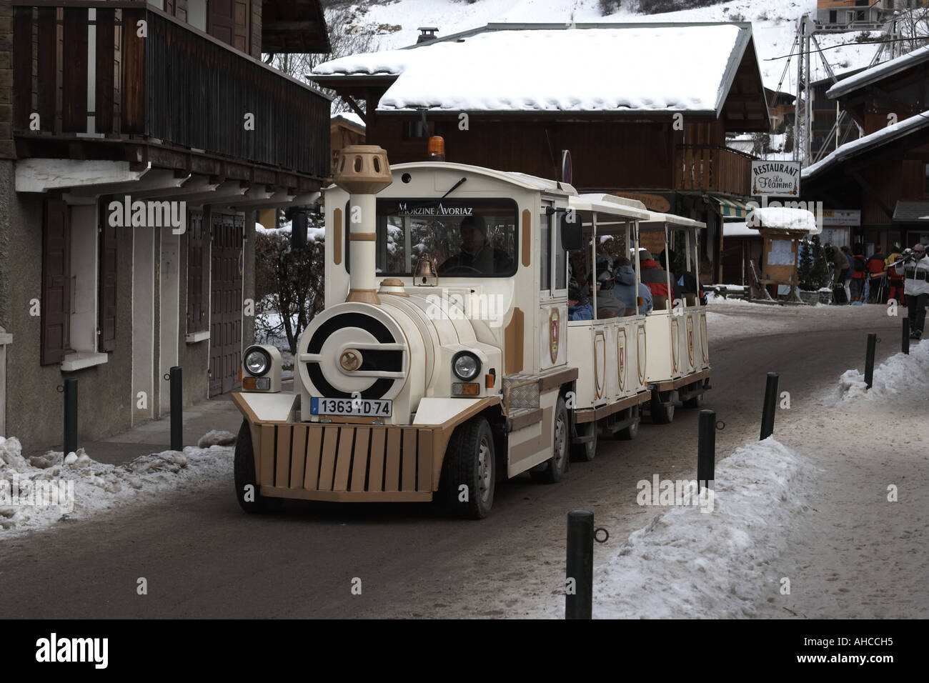 Winter snowy scene with train bus in snow ski resort town of Morzine ...