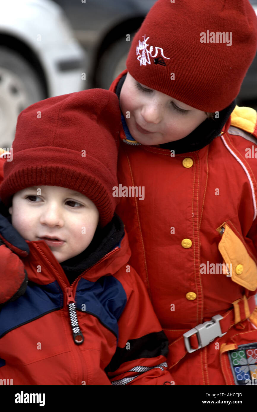 Two young boys children smiling with red hats Stock Photo - Alamy